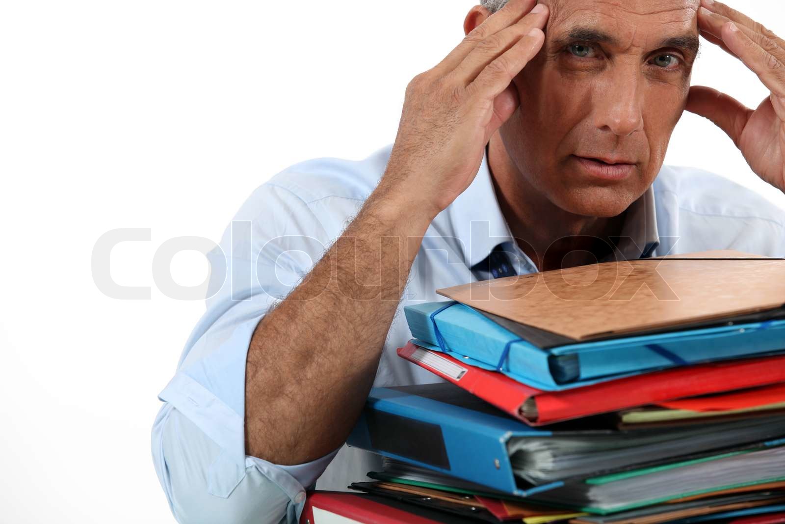 Man with stacks of work | Stock image | Colourbox