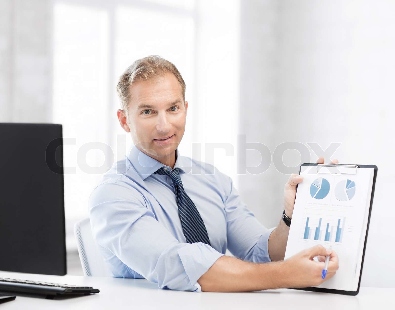 businessman showing graphs and charts | Stock image | Colourbox