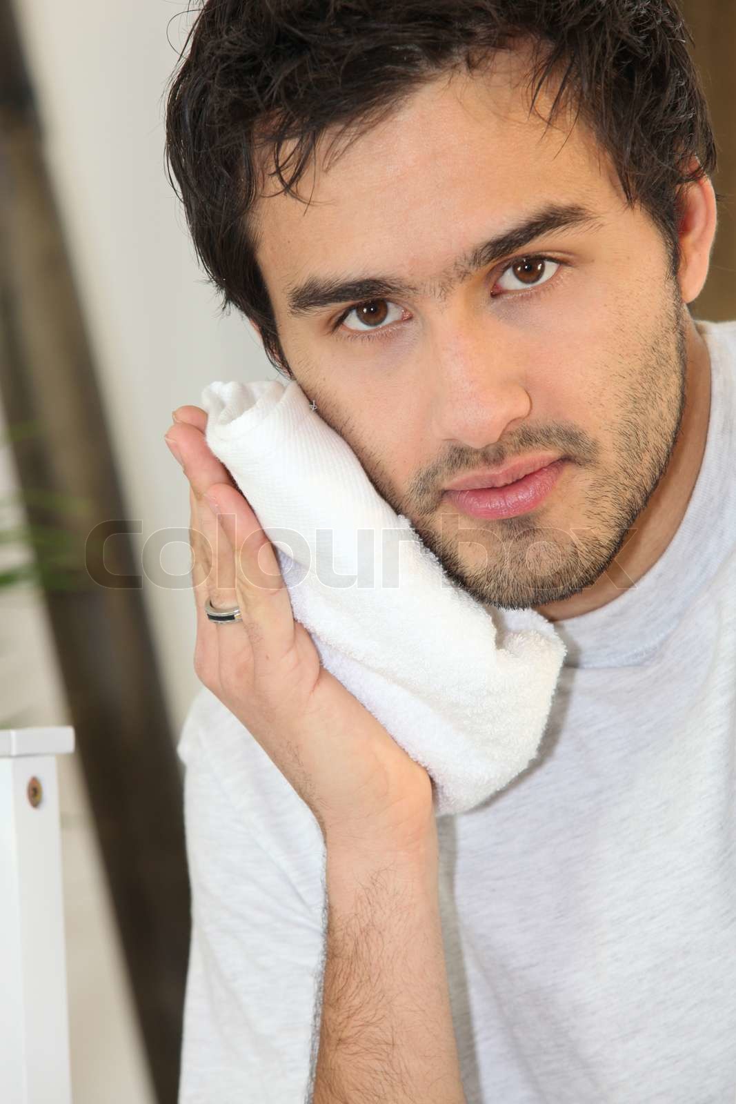 Man drying face with towel | Stock image | Colourbox