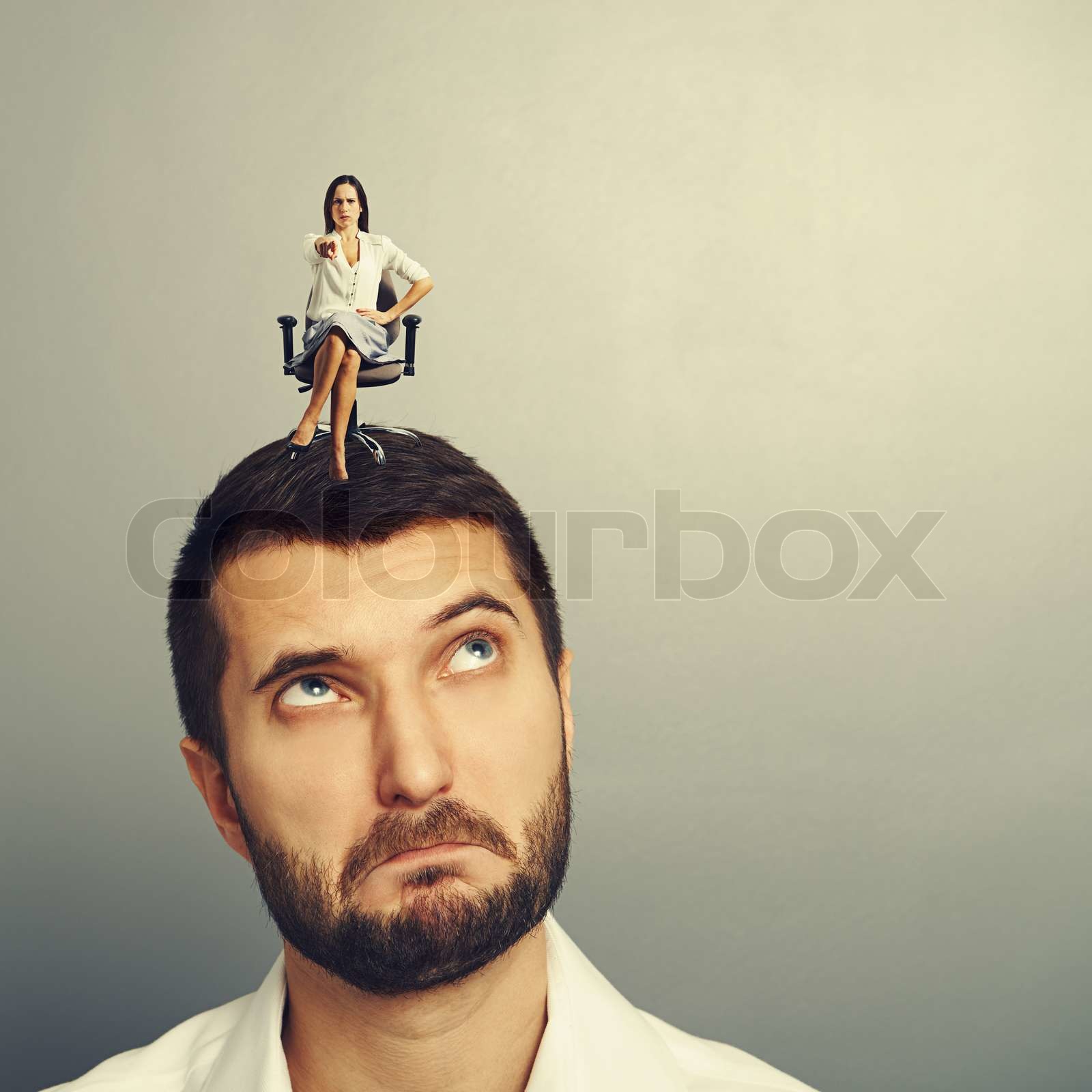 strict woman sitting on the man | Stock image | Colourbox