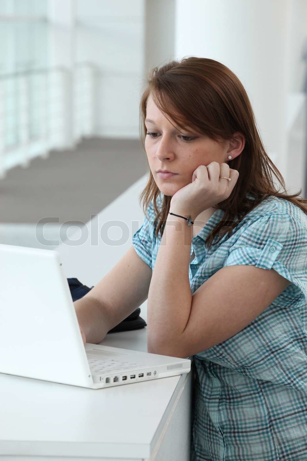 Brunette teenager concentrating on computer screen | Stock image ...