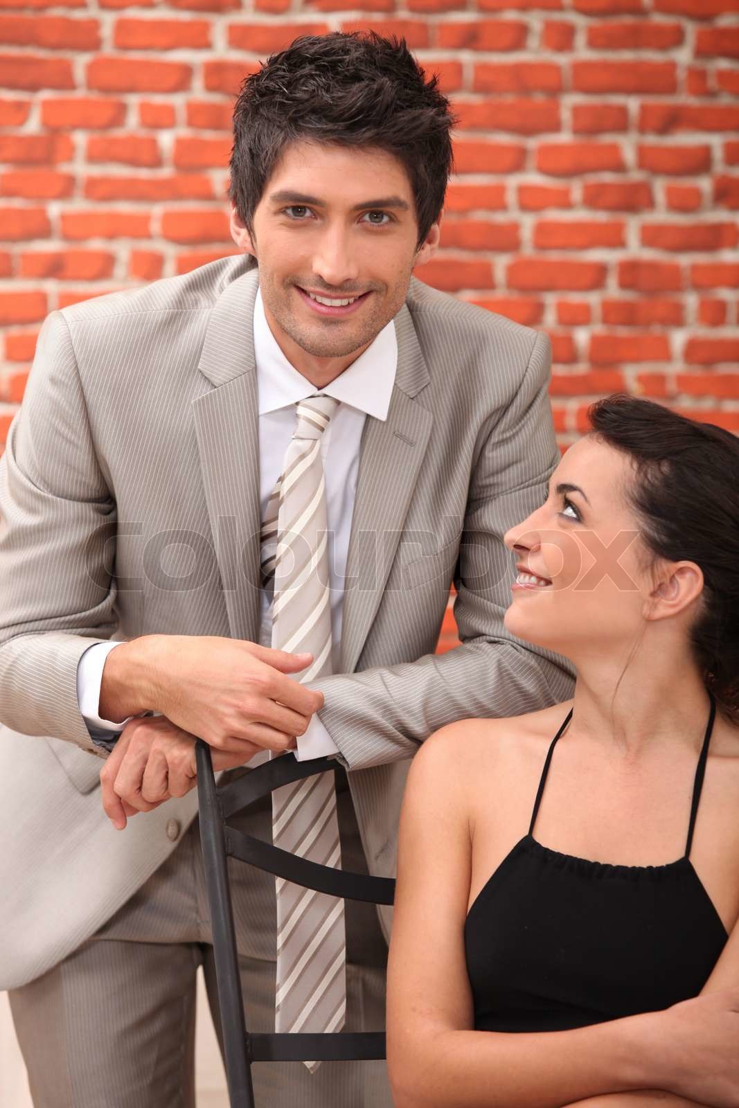 Man in suit sitting behind a woman | Stock image | Colourbox