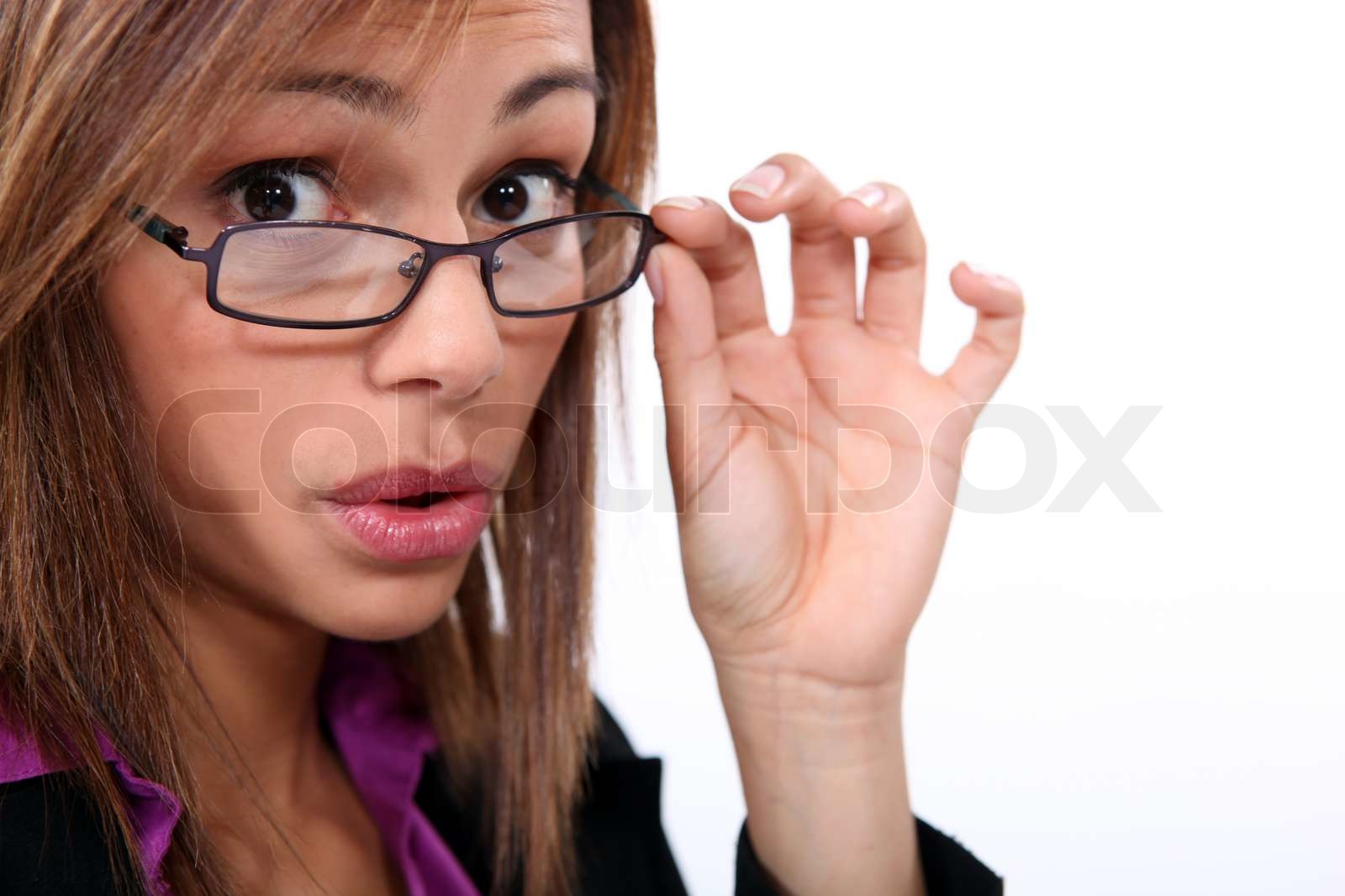 bespectacled woman knitting her brows | Stock image | Colourbox
