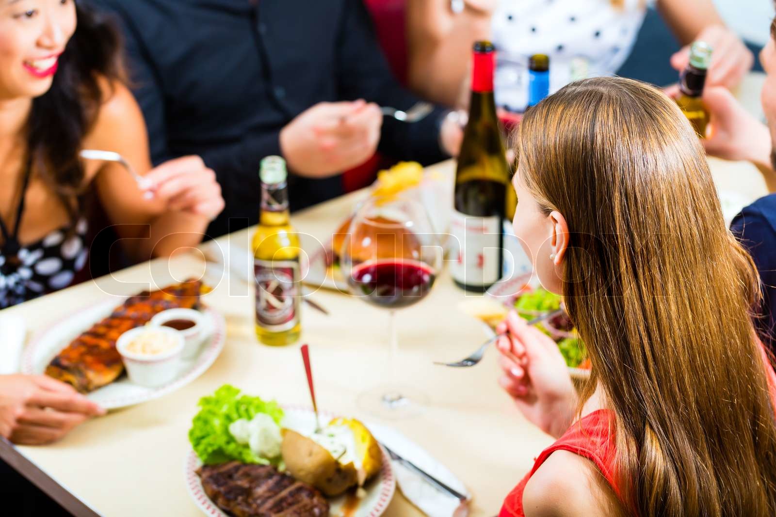 Friends eating and drinking in fast food diner | Stock image | Colourbox