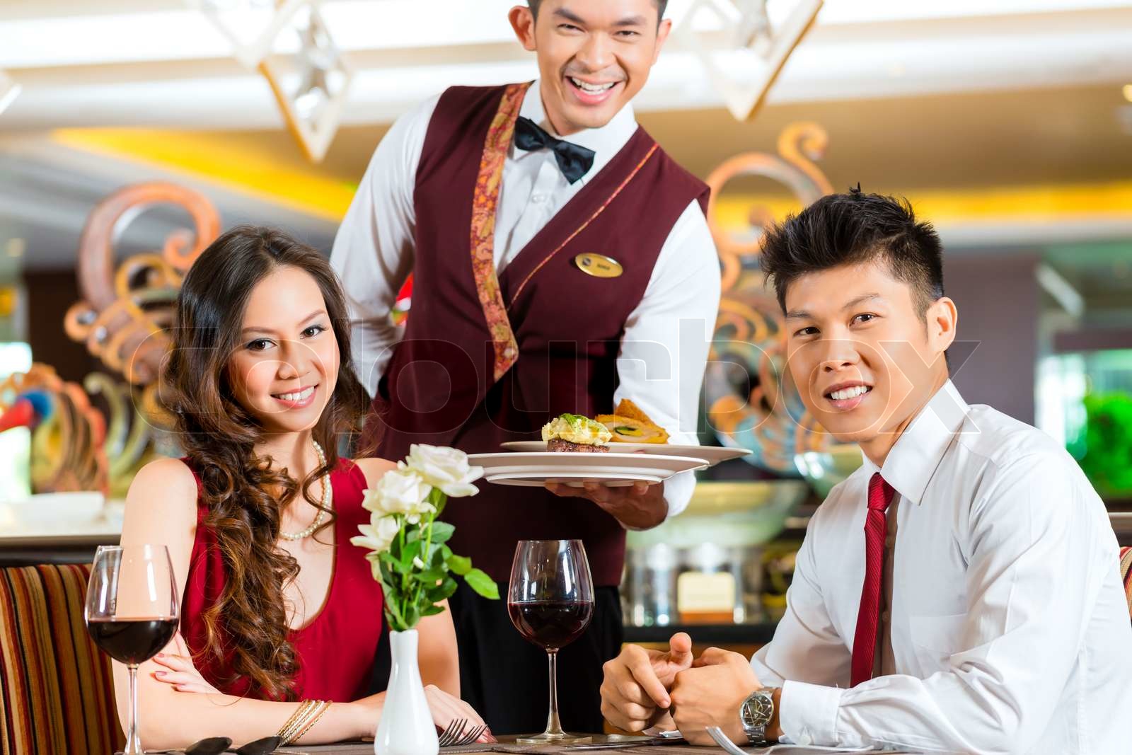 Chinese waiter serving dinner in elegant restaurant or Hotel | Stock ...