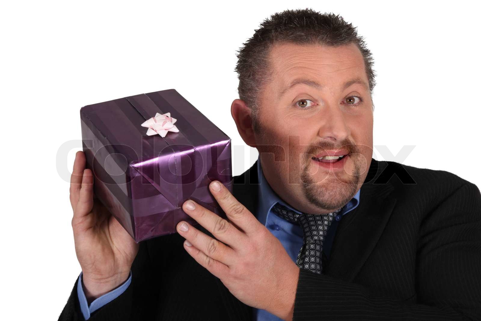 Man shaking a gift | Stock image | Colourbox