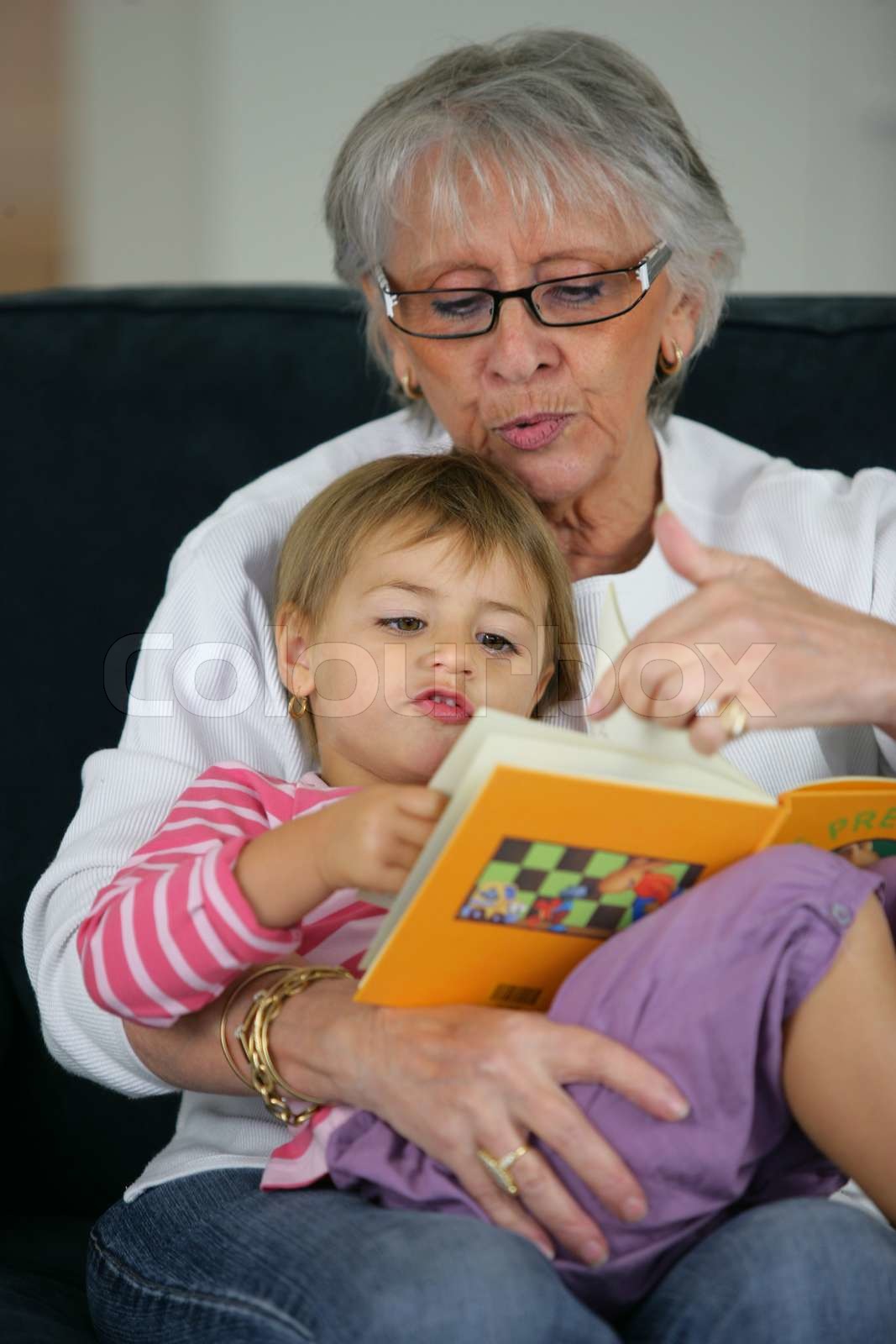 Grandma and child reading together | Stock image | Colourbox