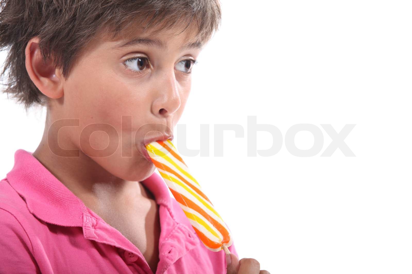 Boy eating lolly pop | Stock image | Colourbox