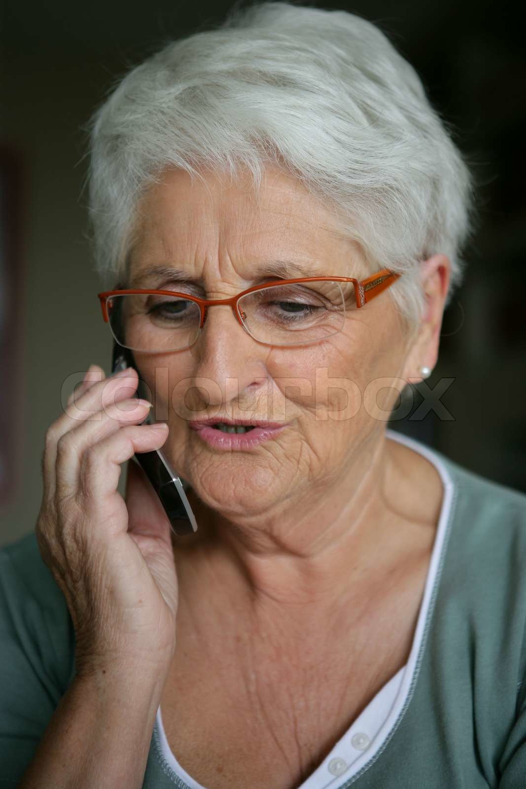 Elderly lady making telephone call | Stock image | Colourbox