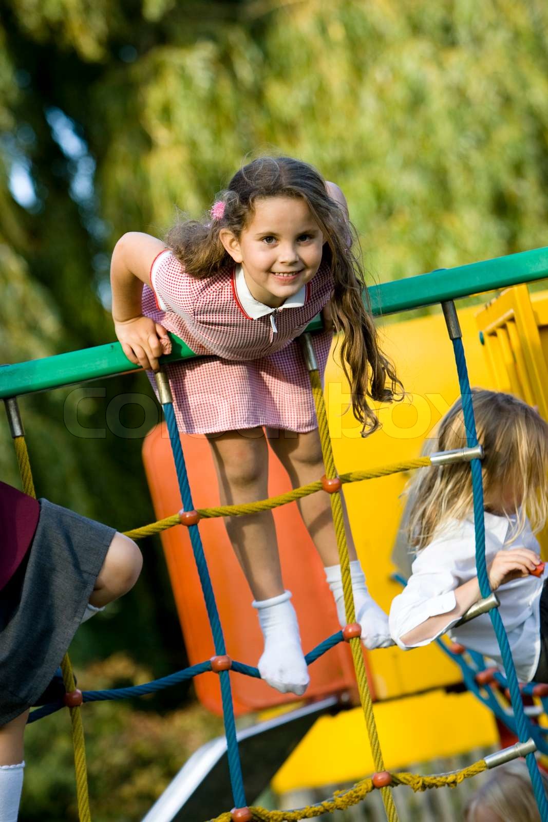 A smiling schoolgirl in a playground | Stock image | Colourbox