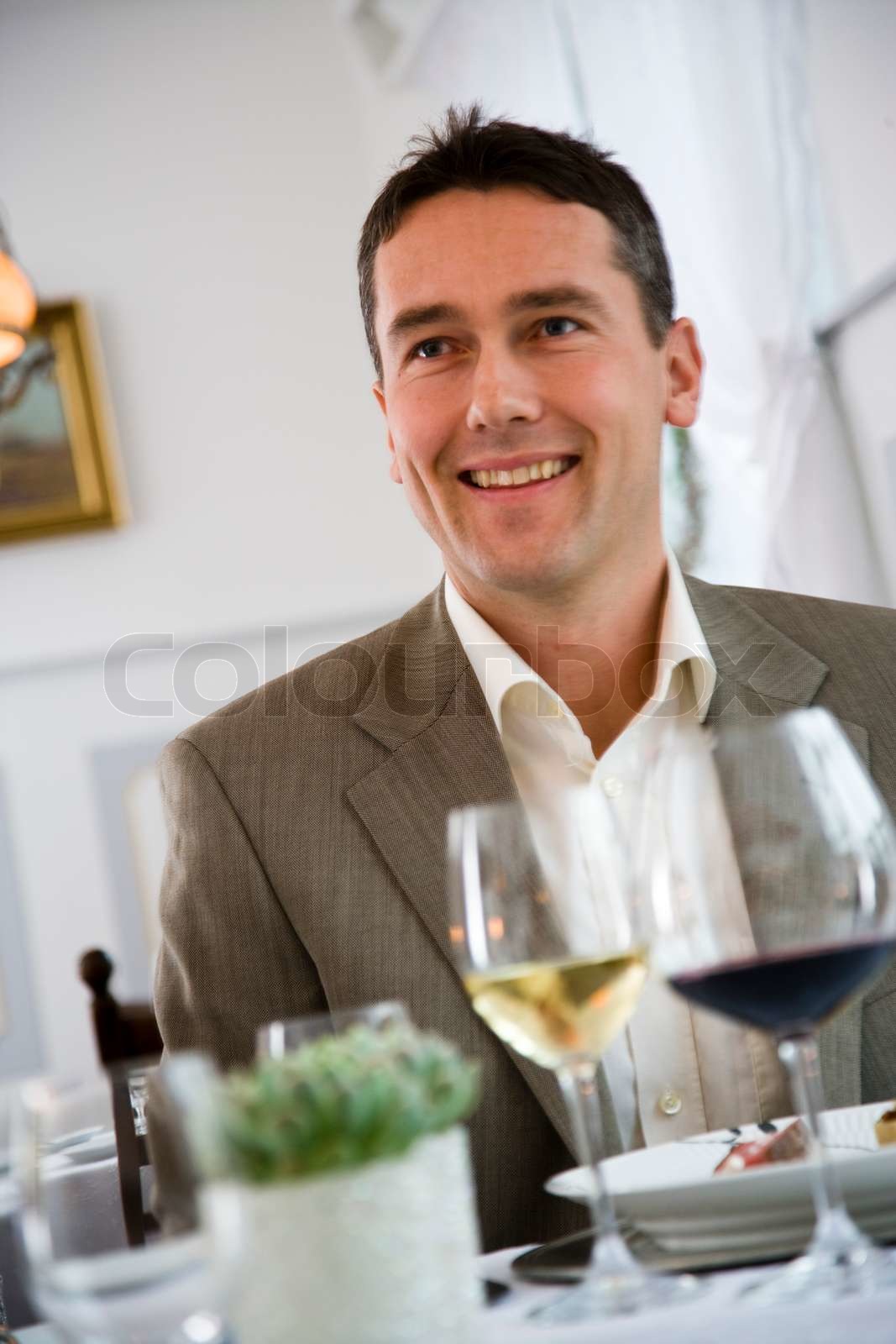 A smiling male guest in a restaurant | Stock image | Colourbox