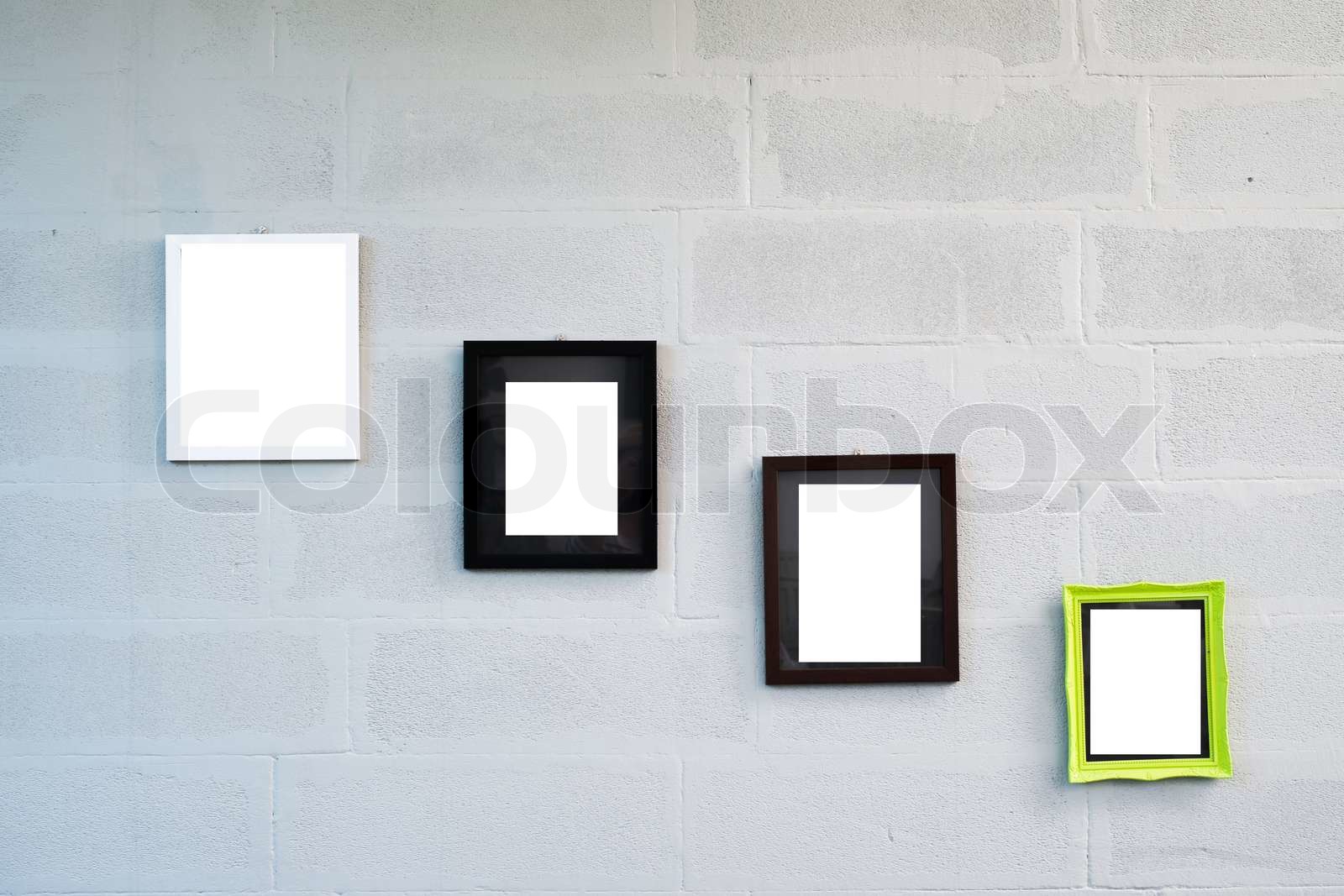 empty photo frames on white concrete wall | Stock image | Colourbox