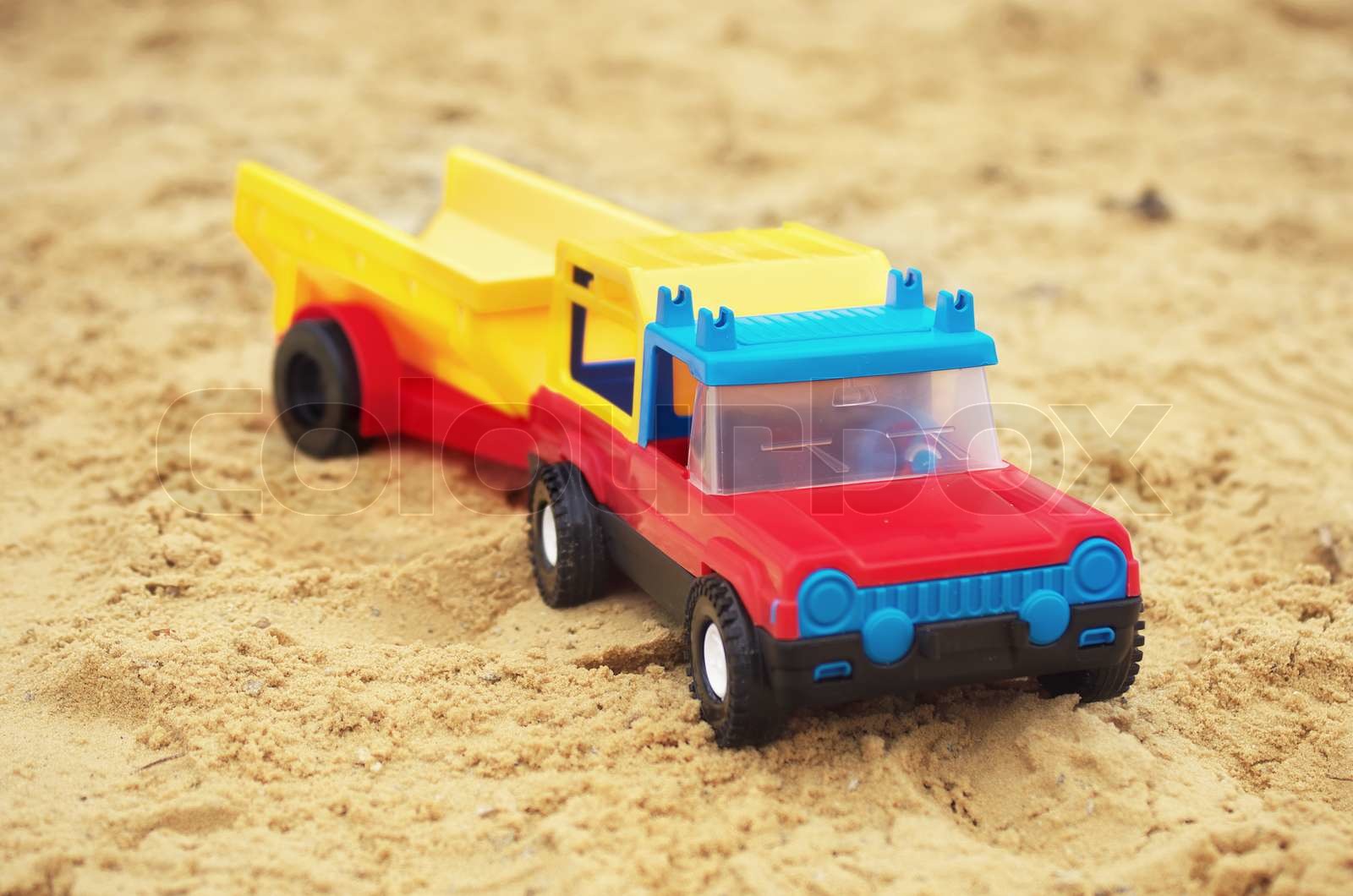 Toy car on sand. | Stock image | Colourbox
