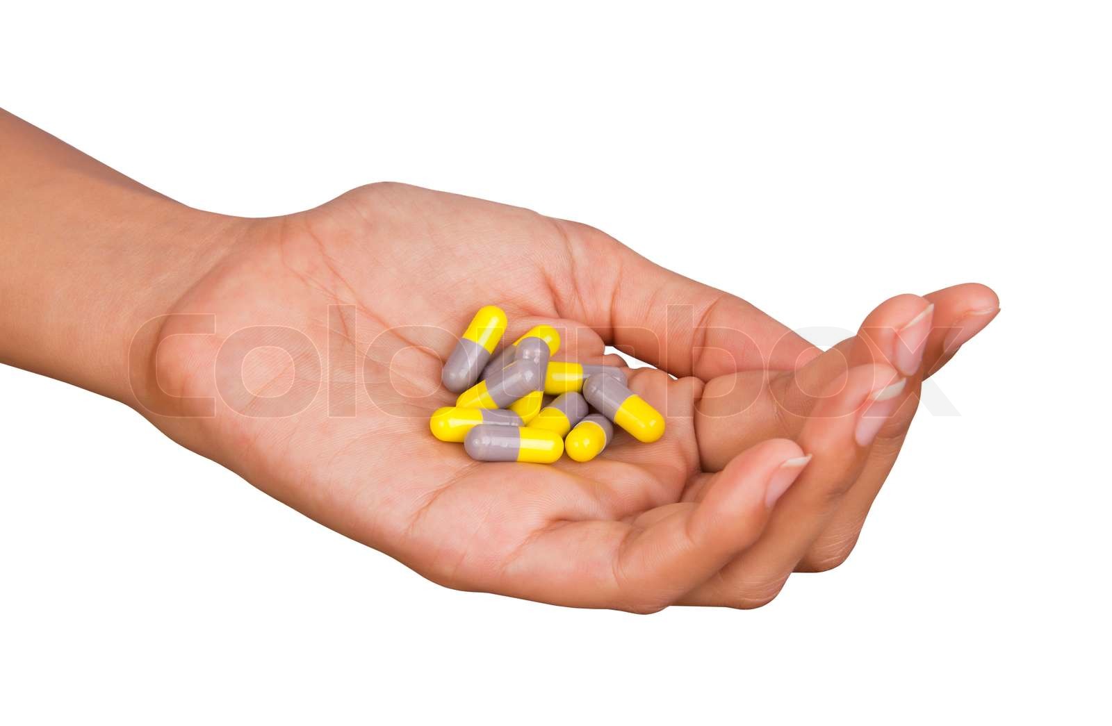 Medicine capsules on hand | Stock image | Colourbox