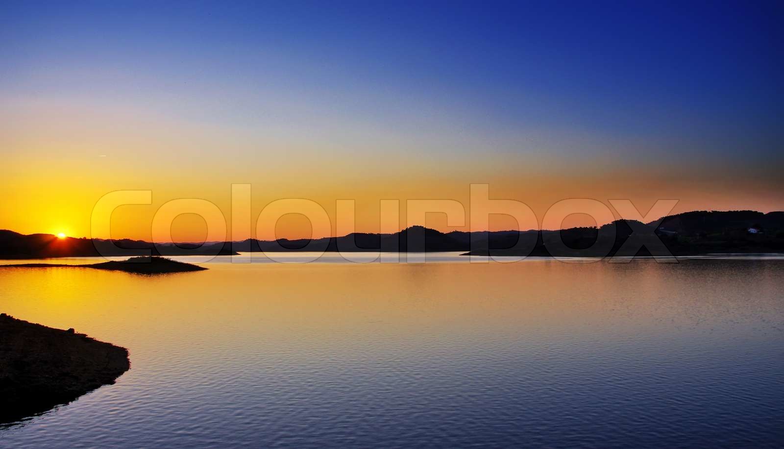 "sunset over the water at dam" | Stock image | Colourbox