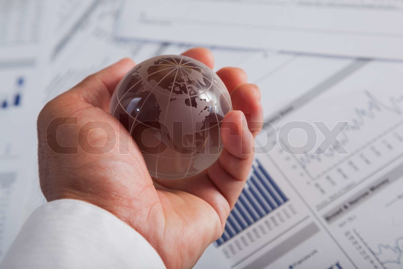 Globe with chart papers. | Stock image | Colourbox