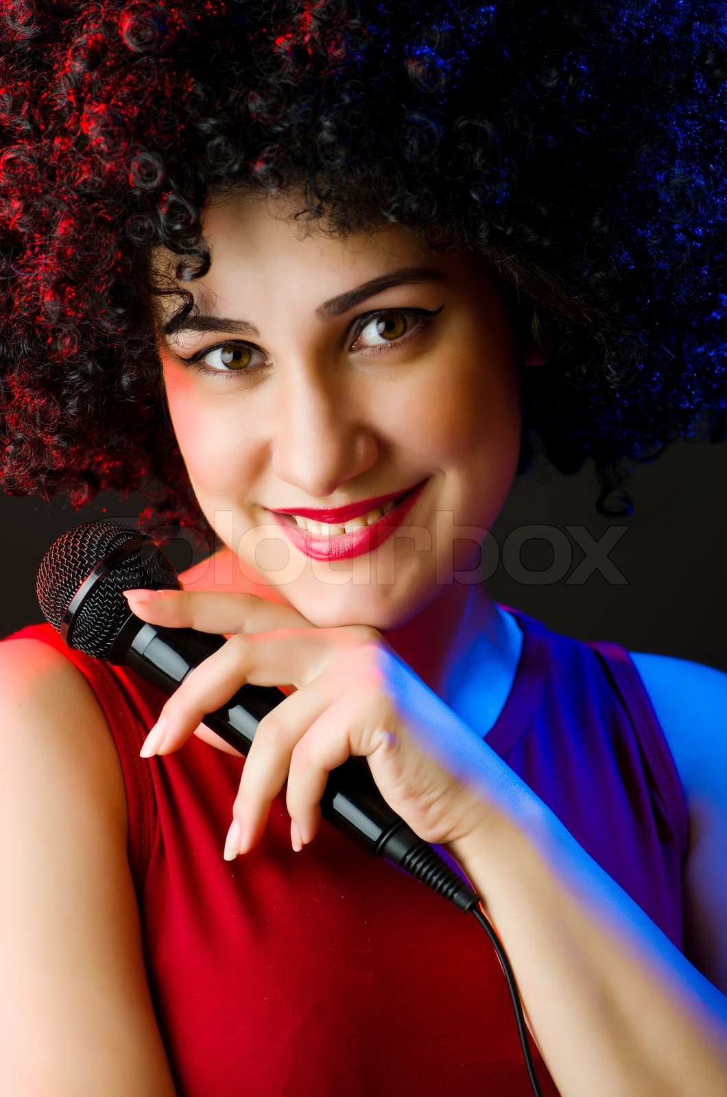 Female performer at disco with mic | Stock image | Colourbox