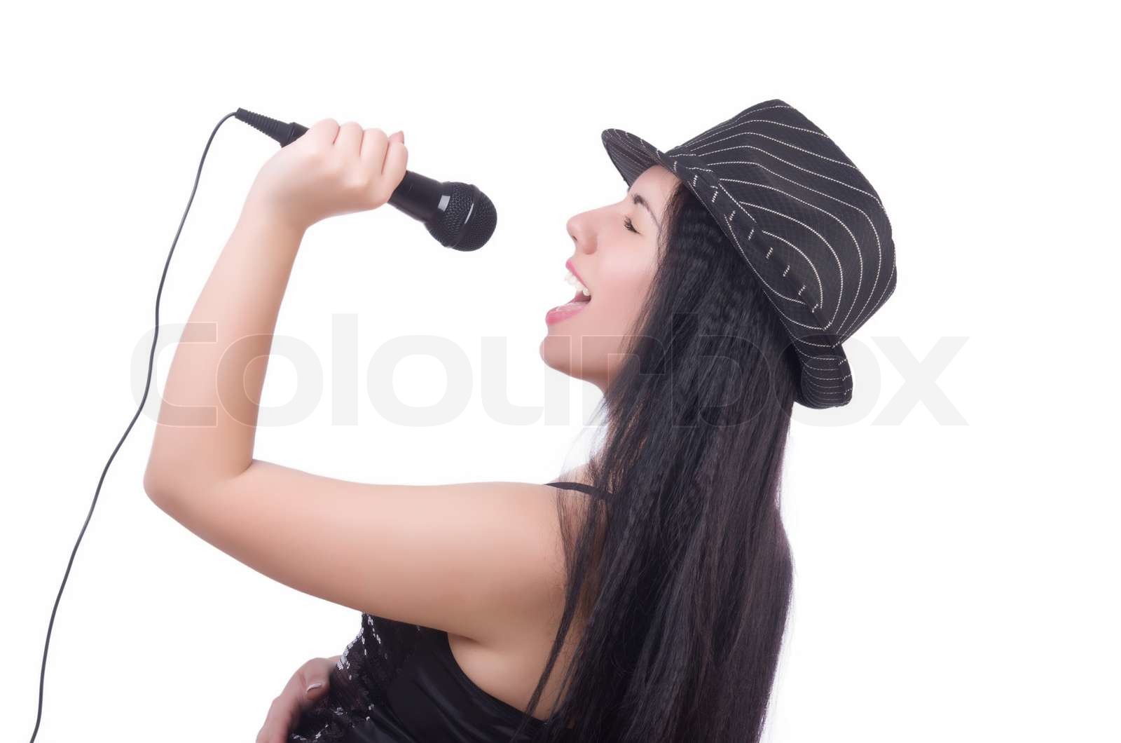 Young female singer with mic on white | Stock image | Colourbox