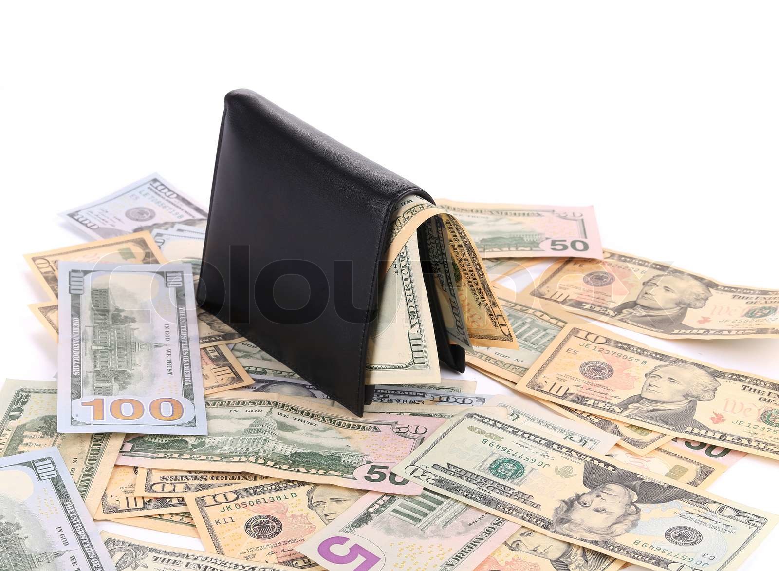 Purse and a bunch of dollars. | Stock image | Colourbox