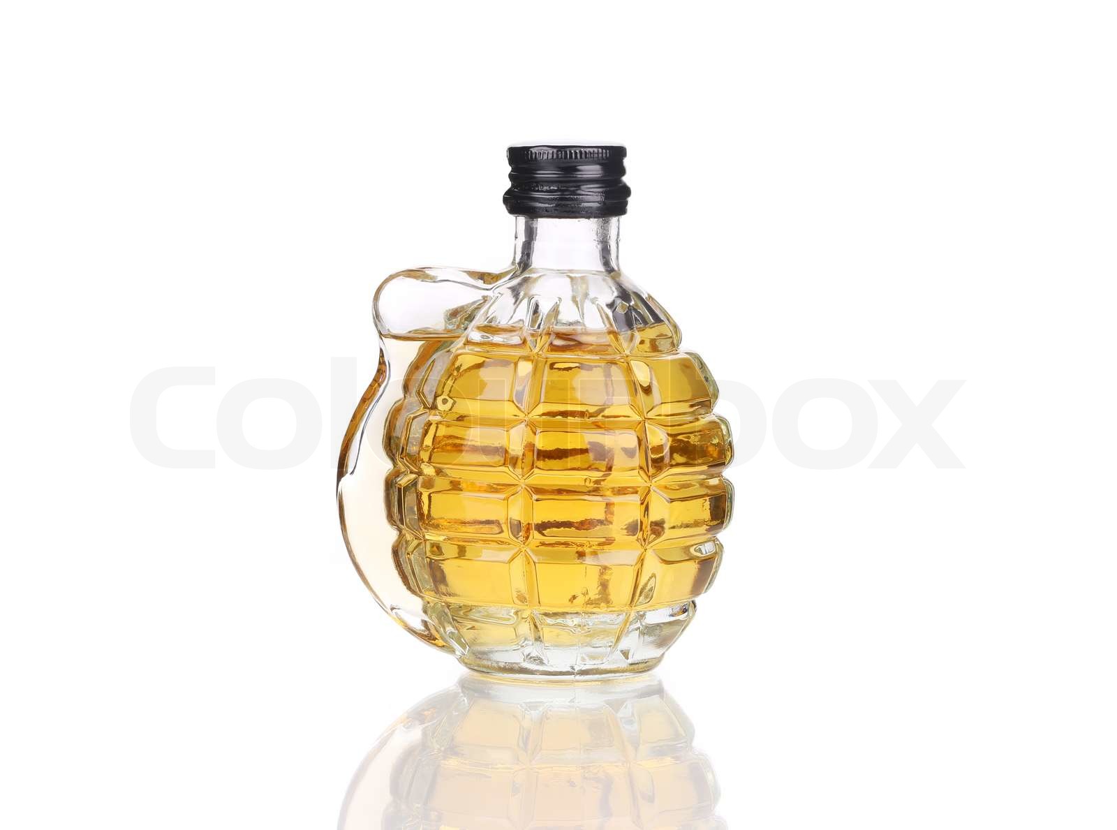 Glass of whiskey with grenade. | Stock image | Colourbox