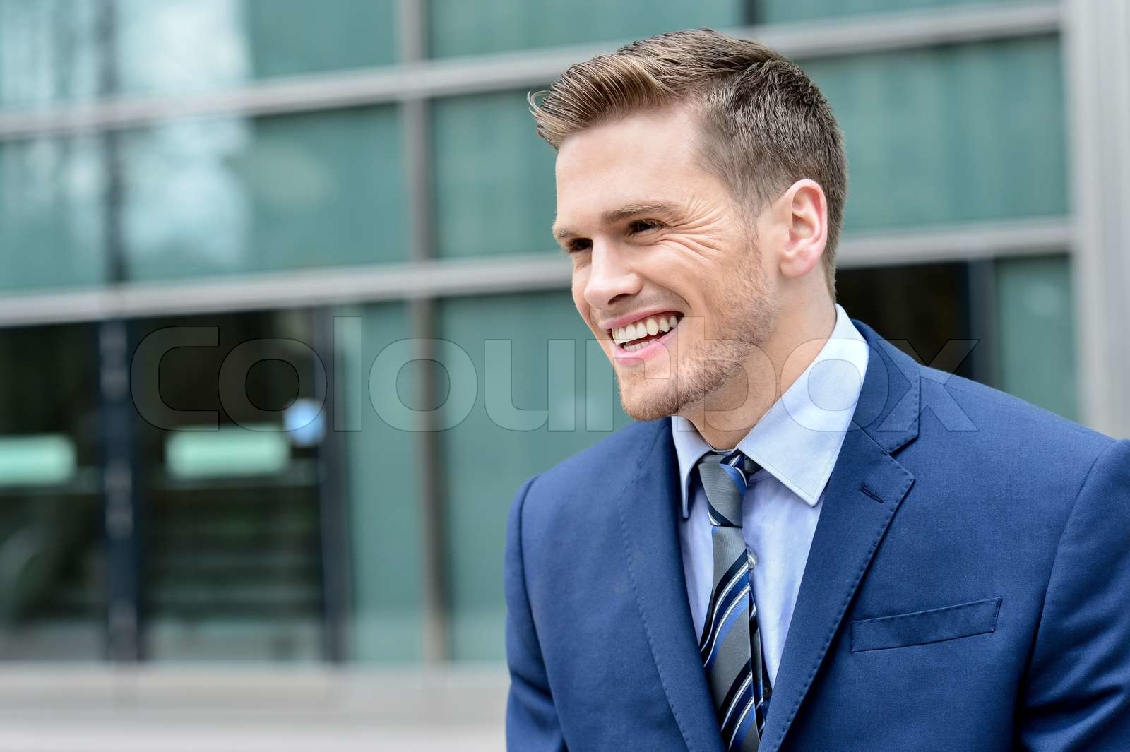 Young smiling relaxed corporate guy | Stock image | Colourbox