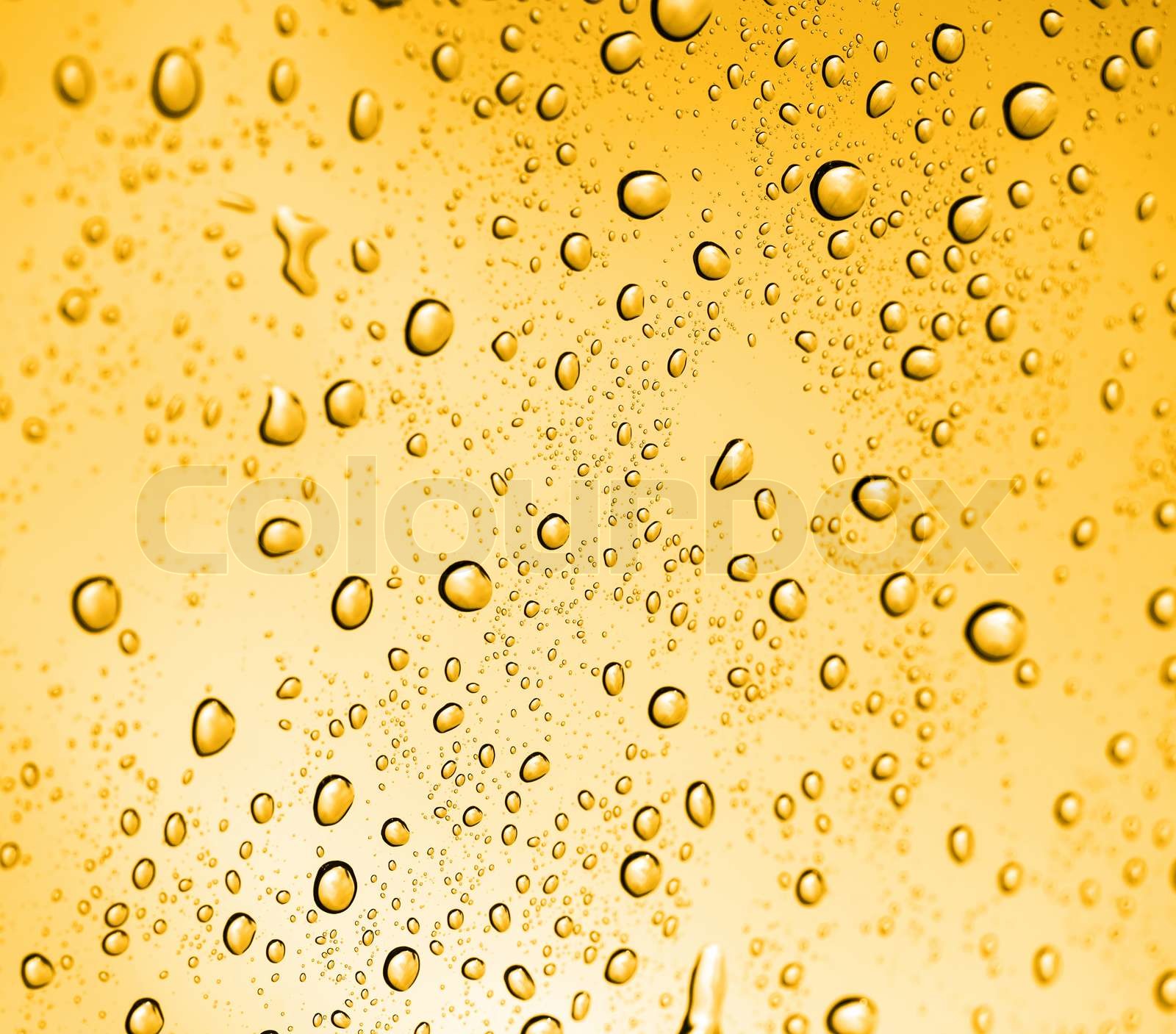 golden water drops on glass | Stock image | Colourbox