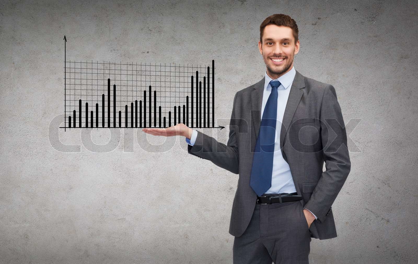 man showing growing chart on the palm of his hand | Stock image | Colourbox