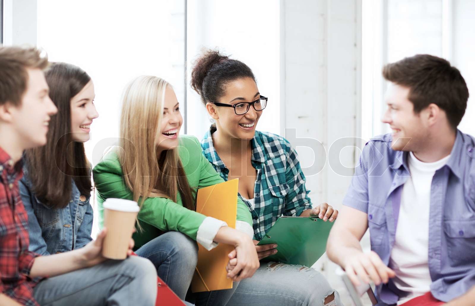 students communicating and laughing at school | Stock image | Colourbox