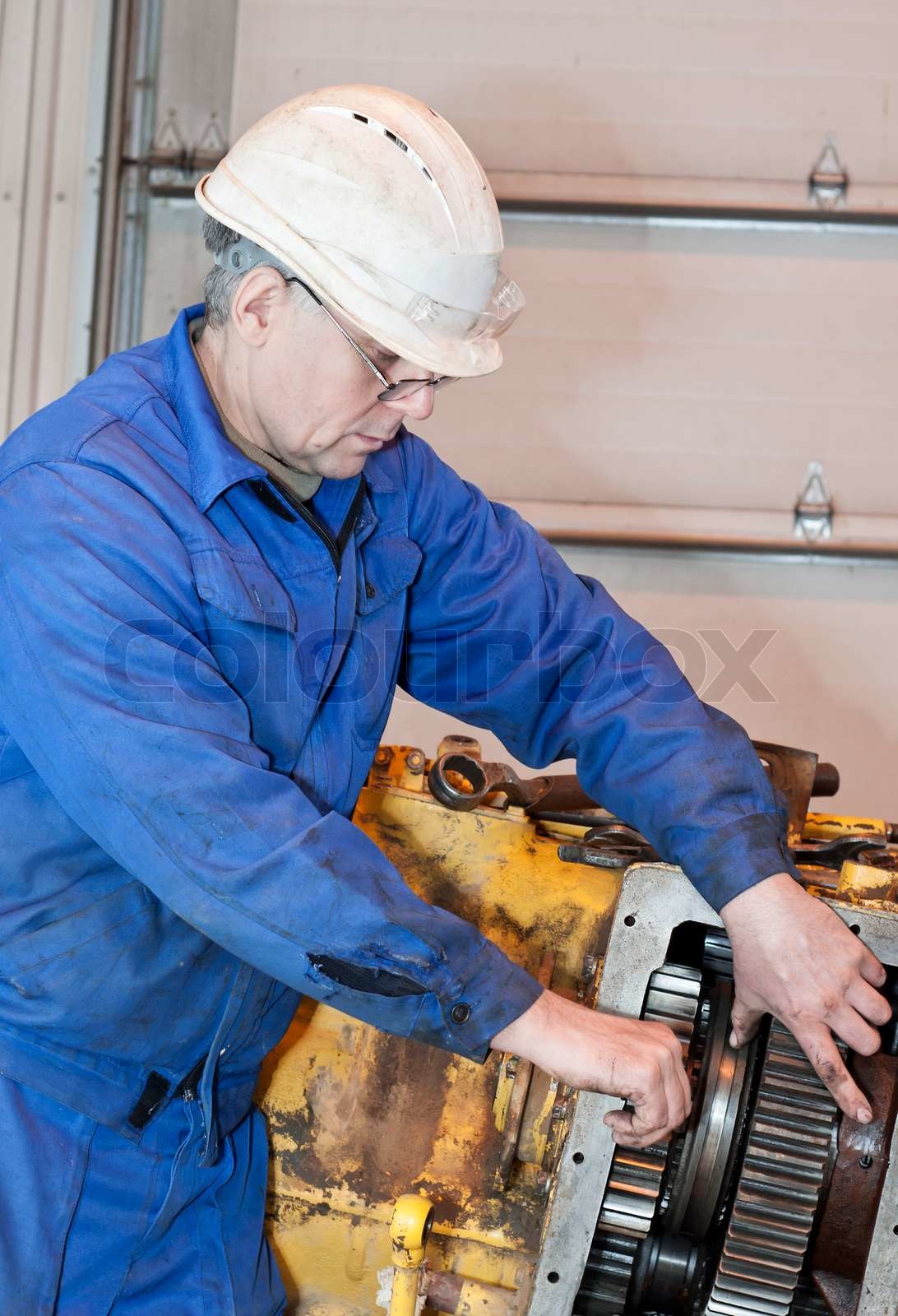 Industrial platform. The mechanic does detail measurement. Engine ...