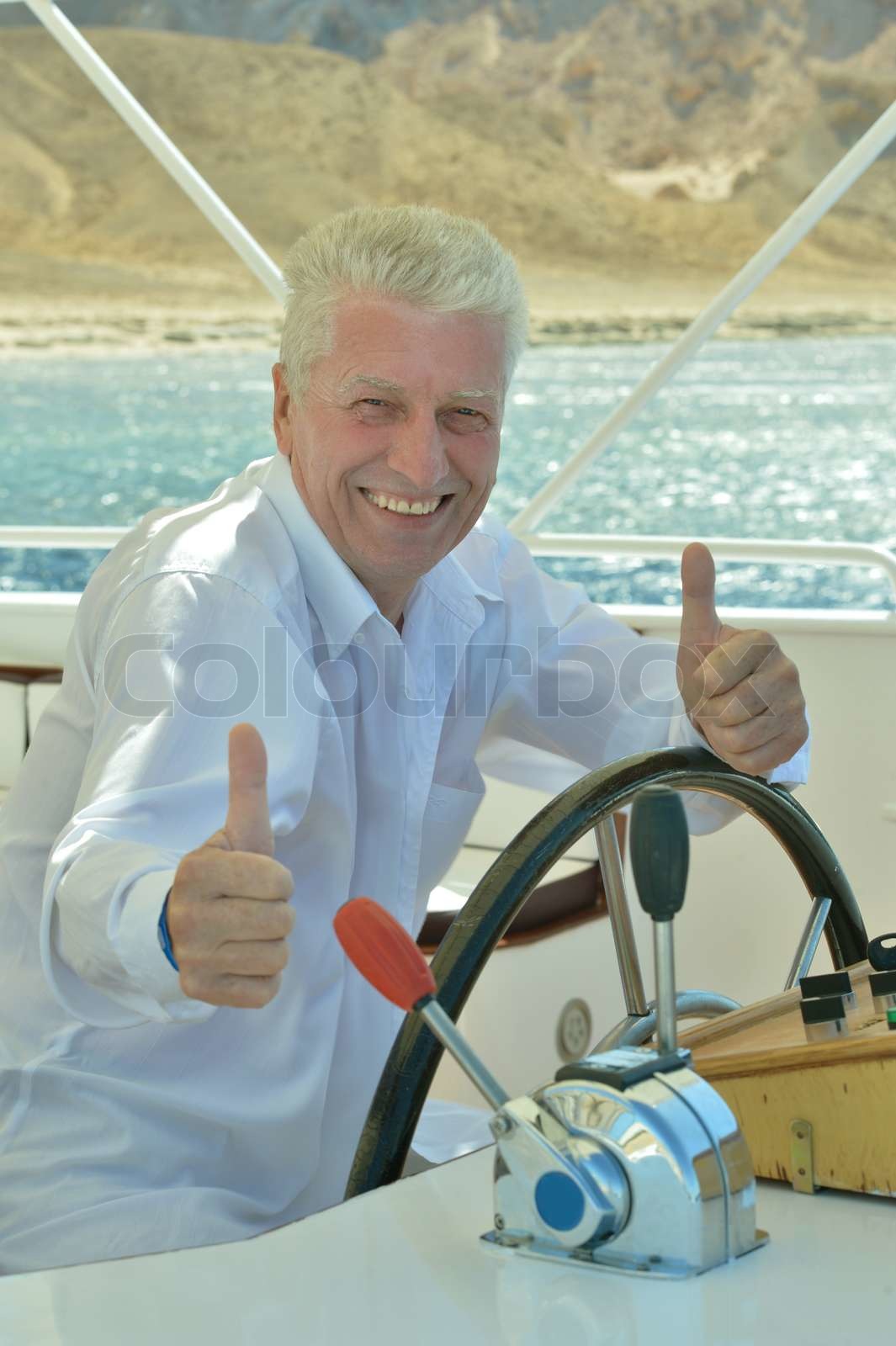 Senior man having boat ride | Stock image | Colourbox