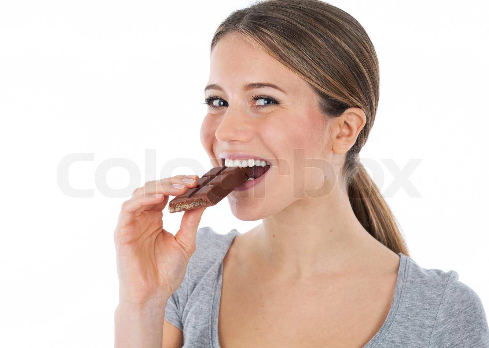 Beautiful woman eating chocolate | Stock image | Colourbox