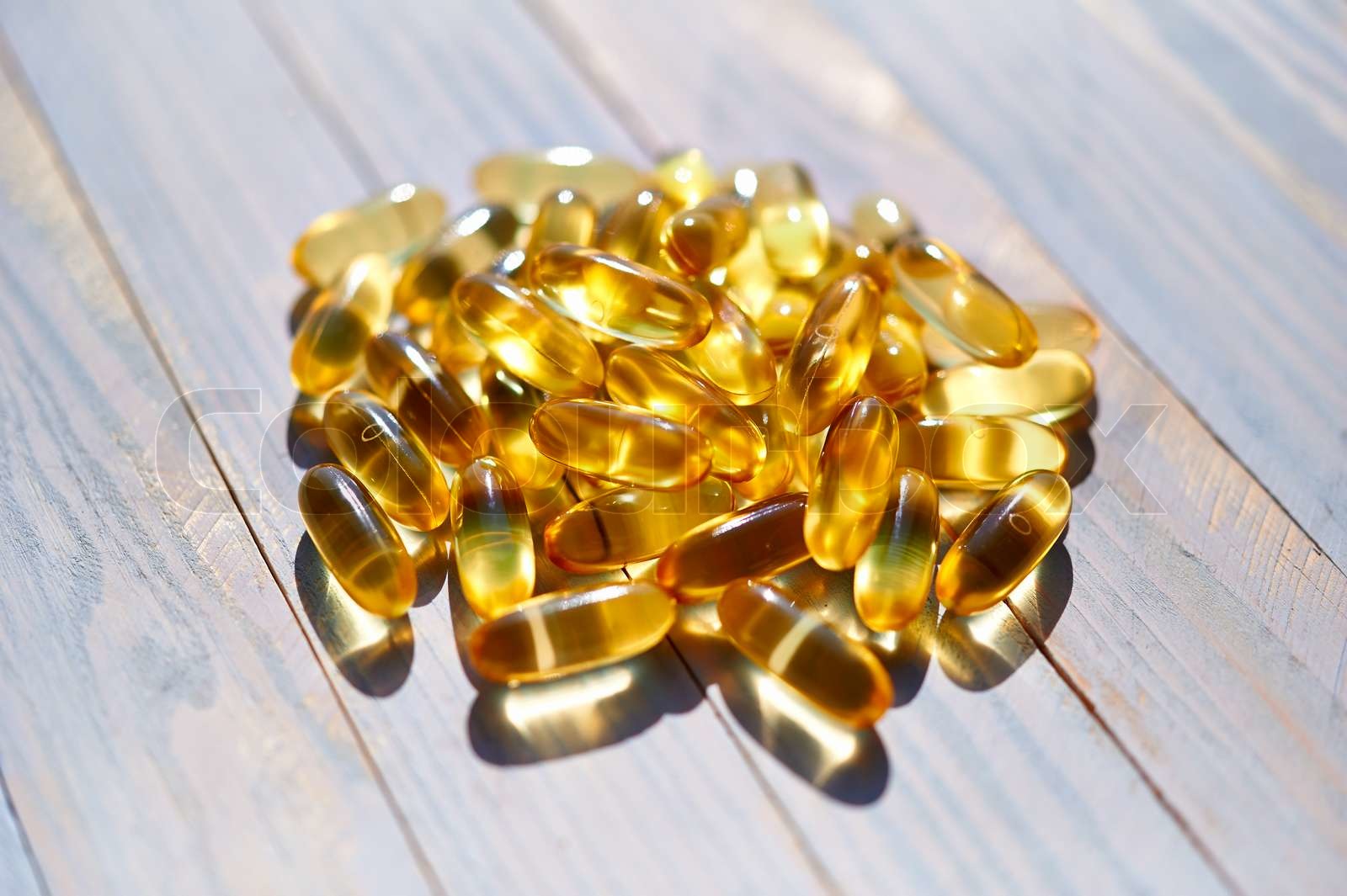 Yellow translucent pills with the fish oil | Stock image | Colourbox