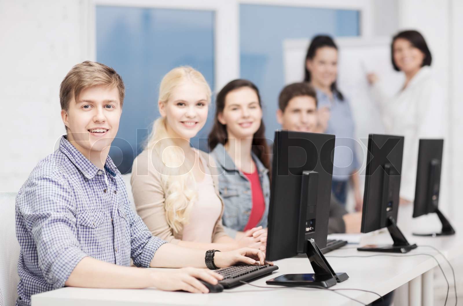 students with computer monitor at school | Stock image | Colourbox