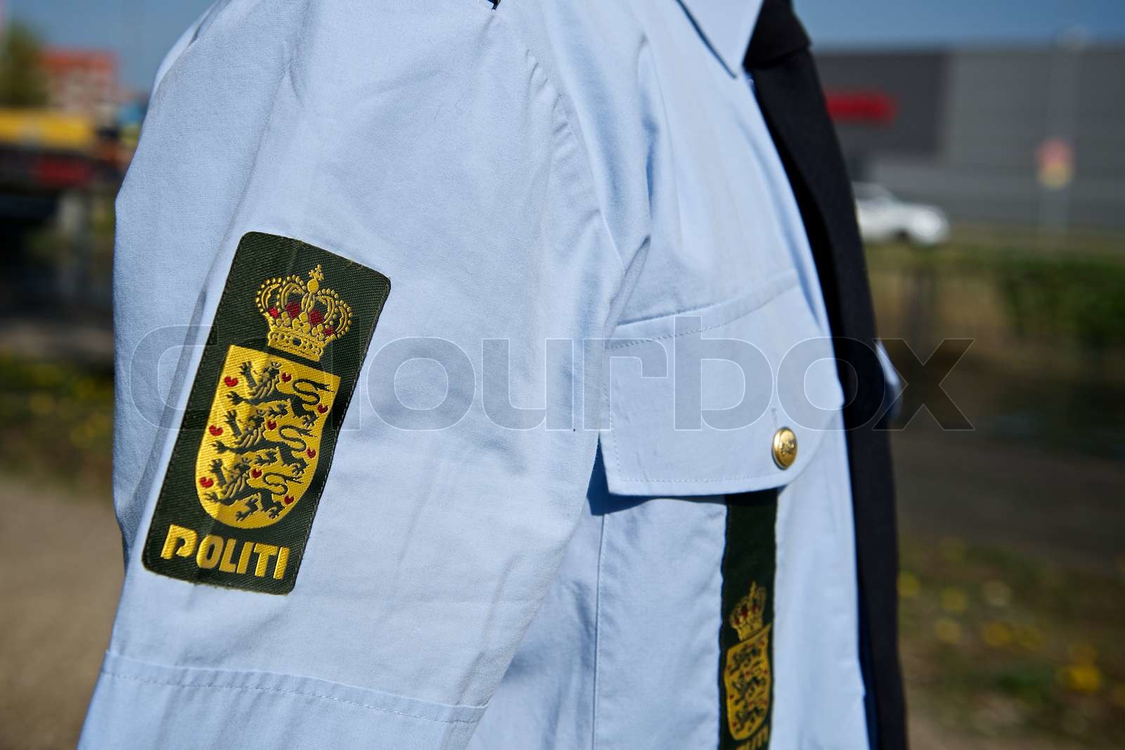Politiuniform med emblem | Stock foto | Colourbox