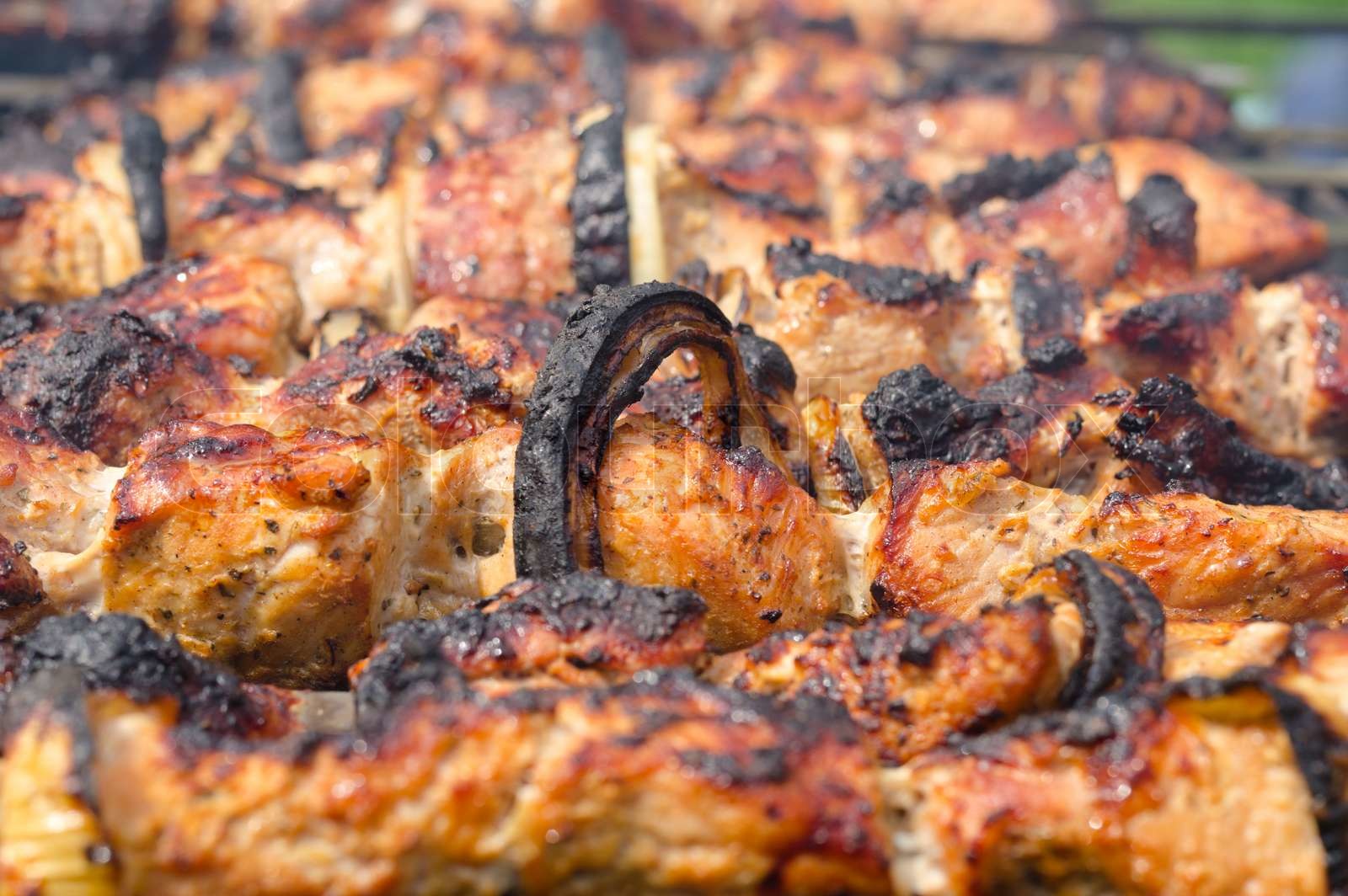 Background of crispy grilled kebabs on a BBQ | Stock image | Colourbox