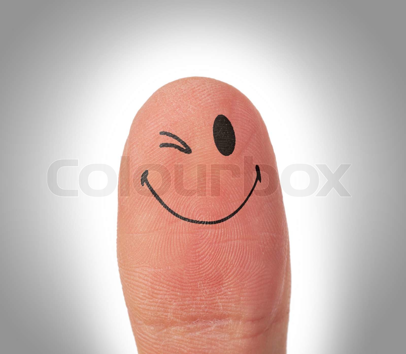 Female thumbs with smile face on the finger | Stock image | Colourbox