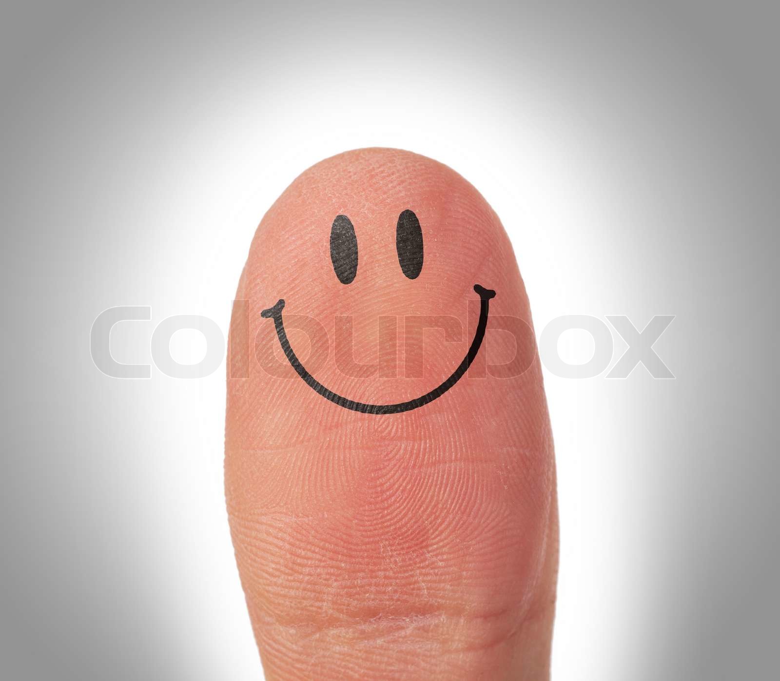 Female thumbs with smile face on the finger | Stock image | Colourbox