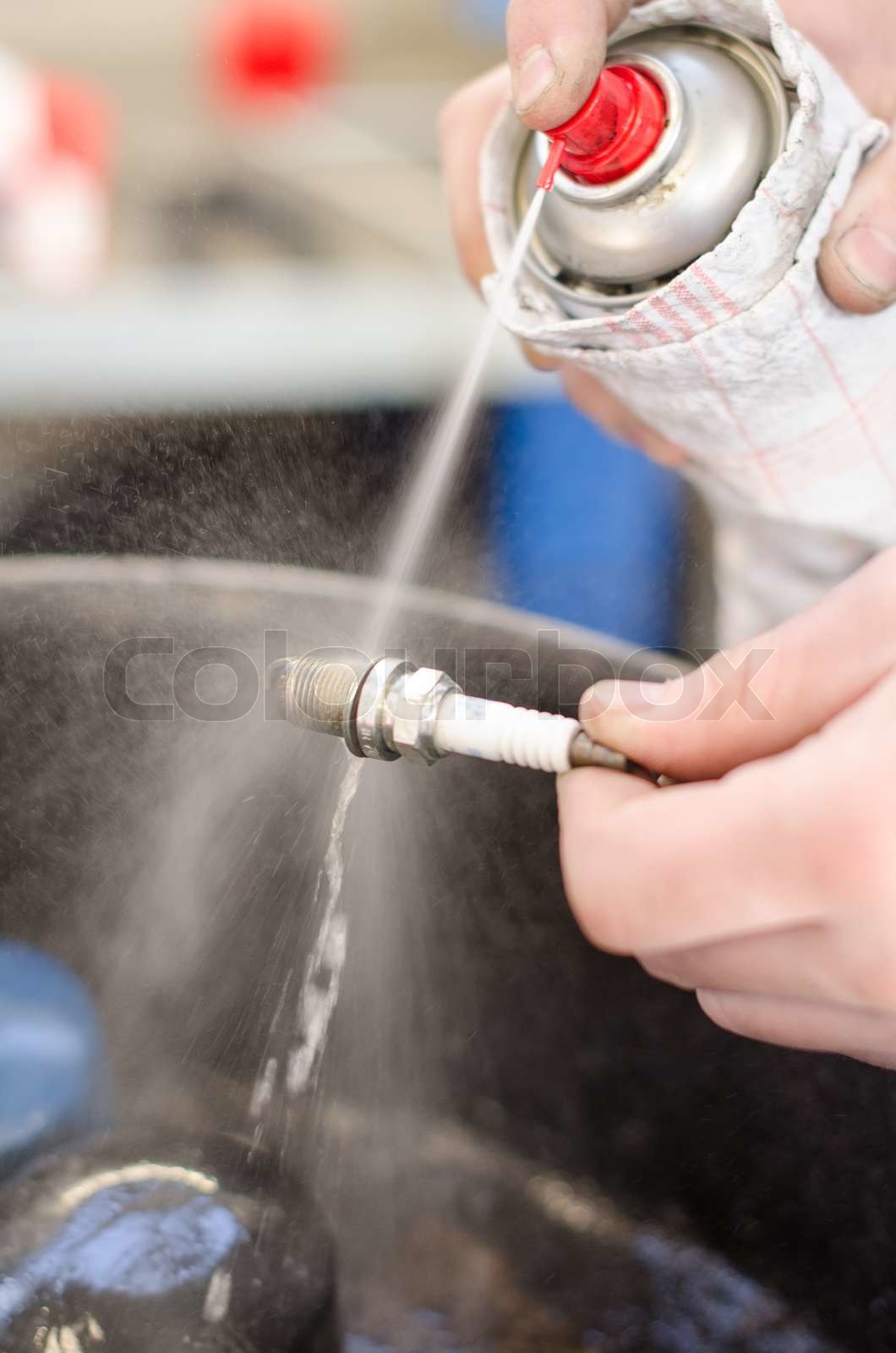 Spark plug cleaning in repair shop. | Stock image | Colourbox