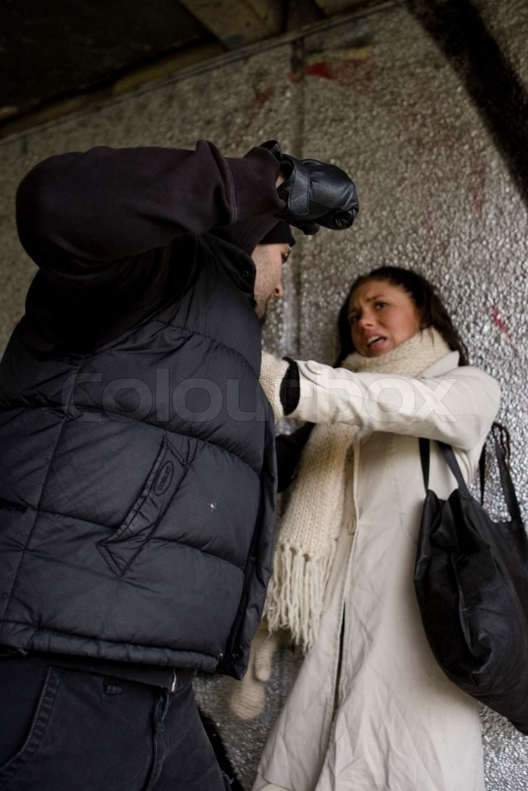 A male mugger attacking a female victim | Stock image | Colourbox