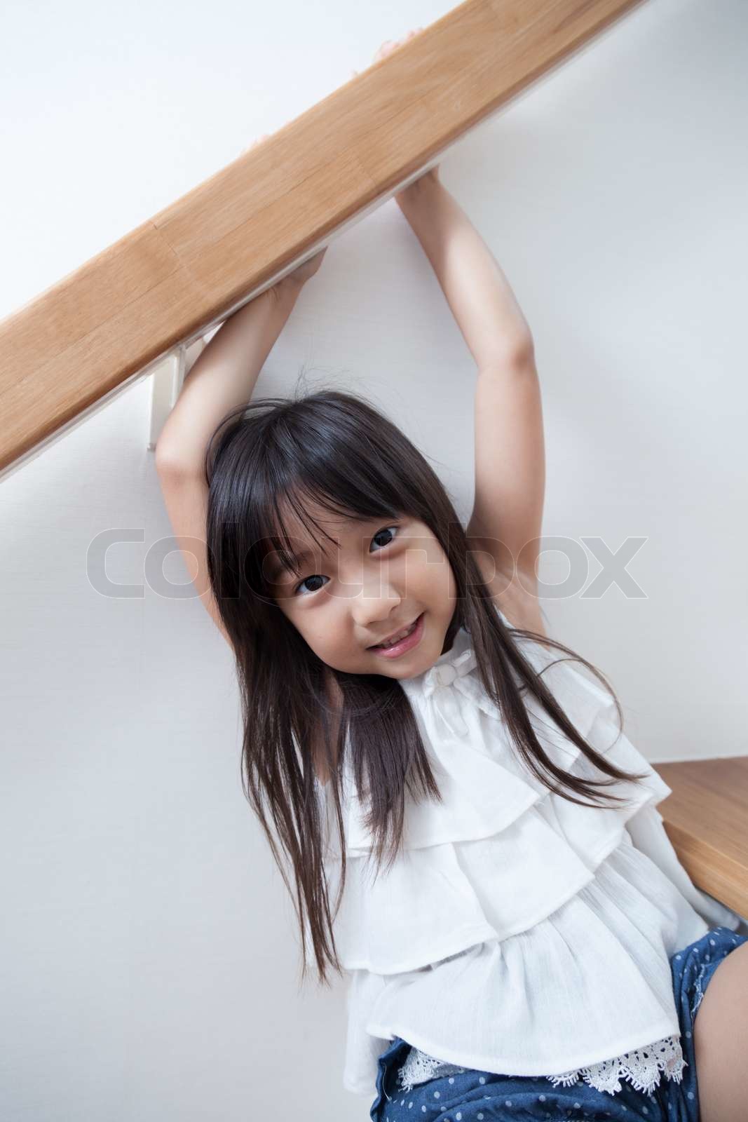 Girl sitting in on the ladder | Stock image | Colourbox
