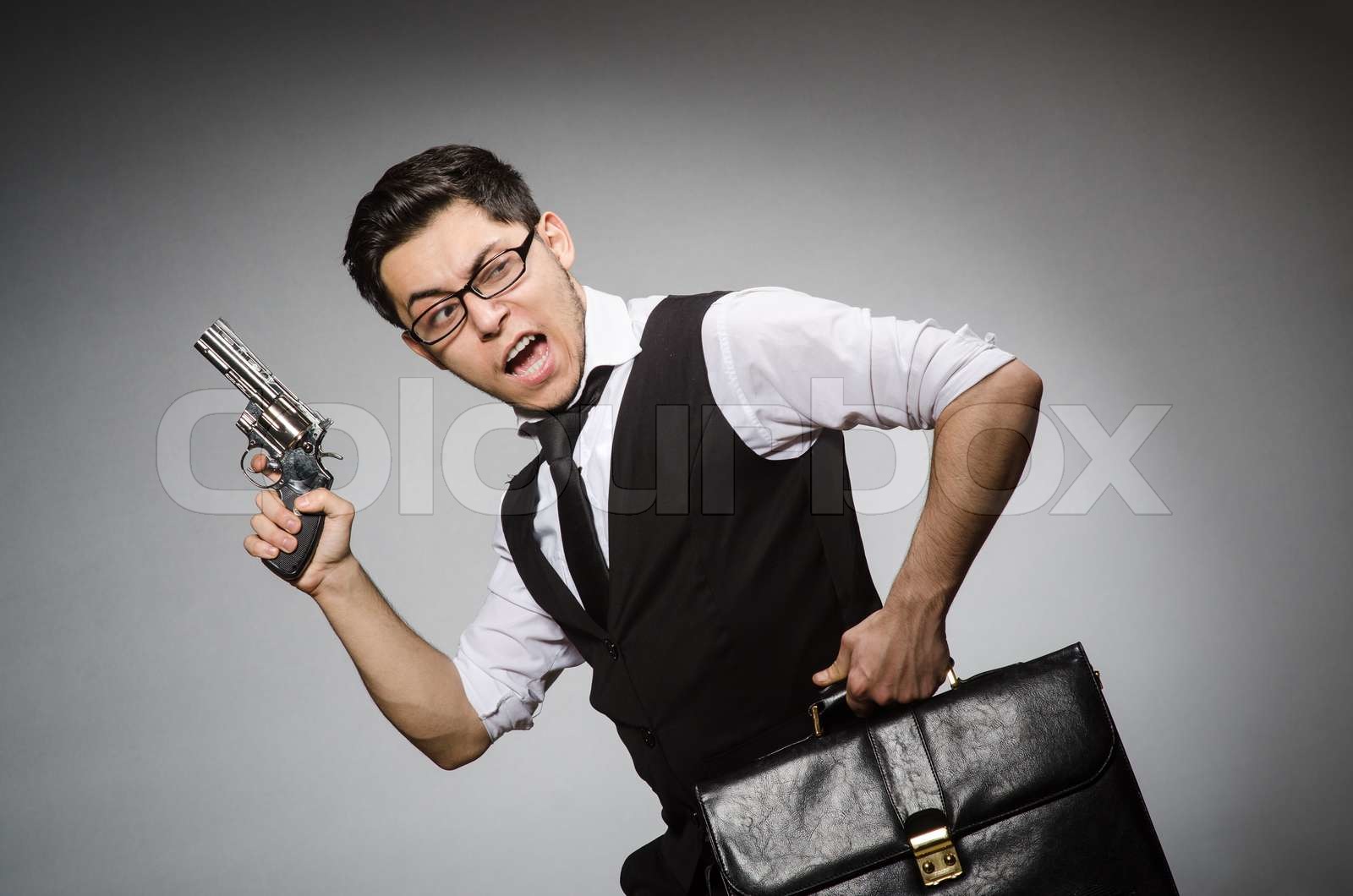 Man with gun and briefcase | Stock image | Colourbox