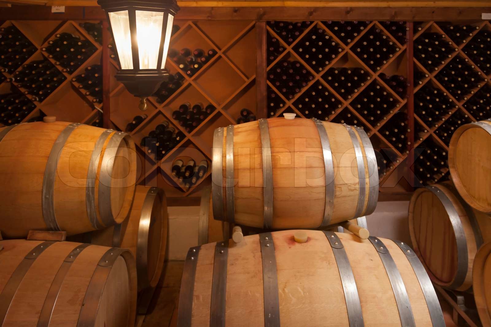 Wine Barrels and Bottles in Cellar | Stock image | Colourbox
