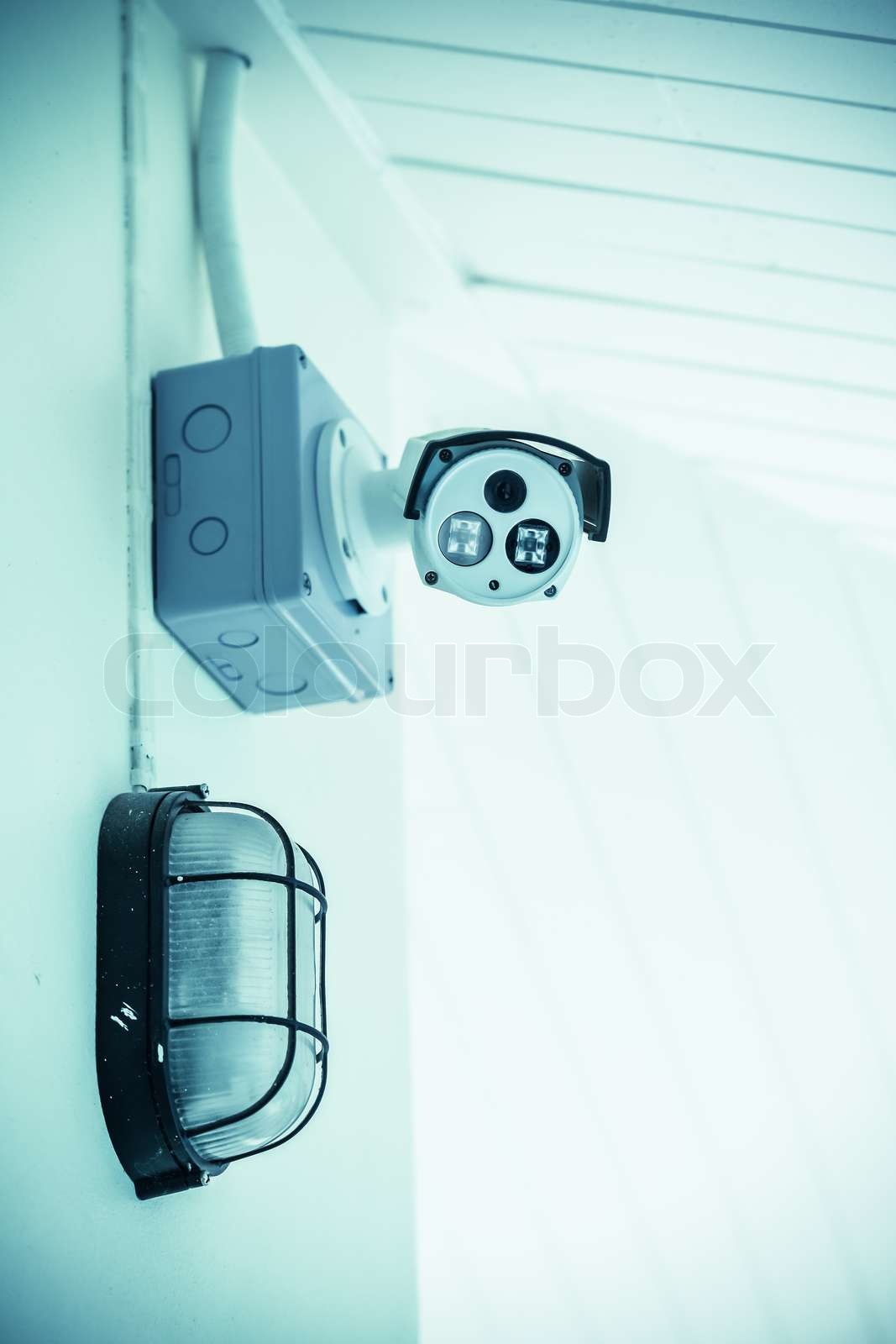 CCTV Camera on the white wall with blue filter effect. | Stock image ...
