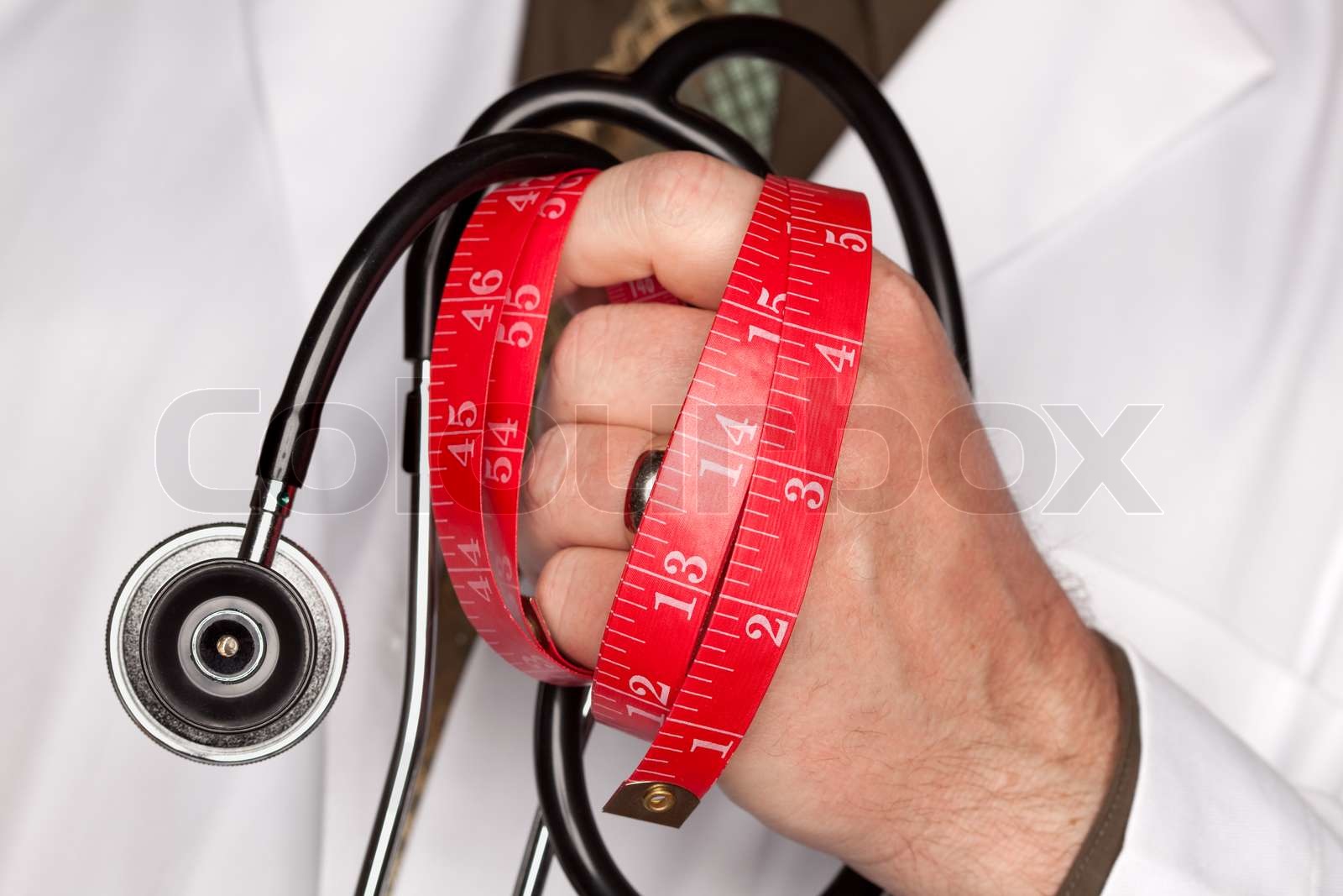 Doctor with Stethoscope Holding Measuring Tape | Stock image | Colourbox