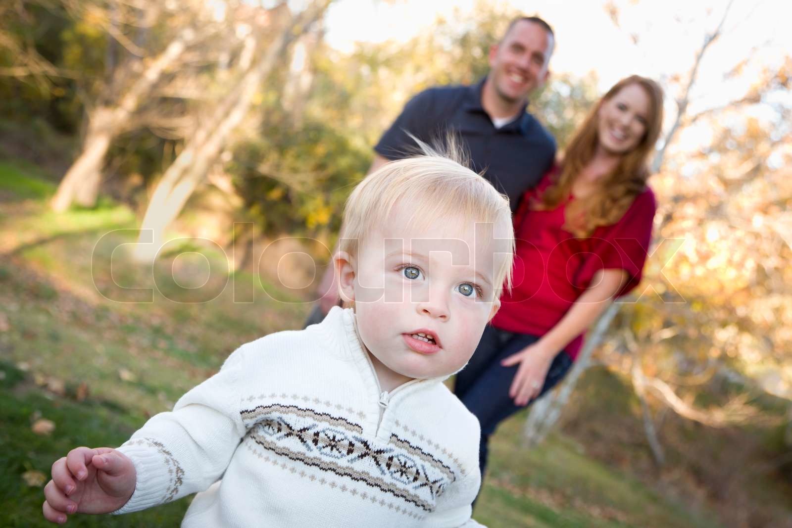 Cute Young Boy Walking as Parents Look On From Behind | Stock image ...