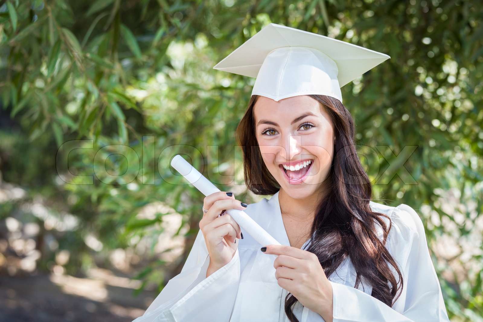 Graduating Mixed Race Girl In Cap and Gown with Diploma | Stock image ...