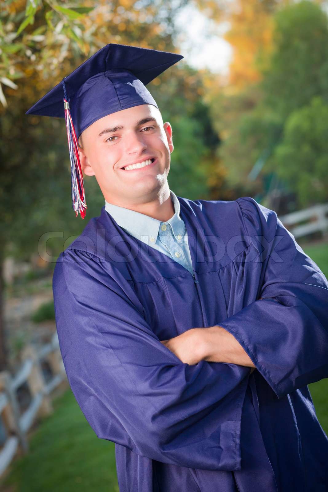 Handsome Male Graduate in Cap and Gown | Stock image | Colourbox
