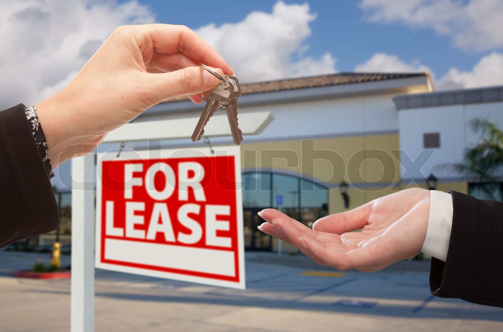 Handing Over Keys in Front of Business Office and Sign | Stock image ...