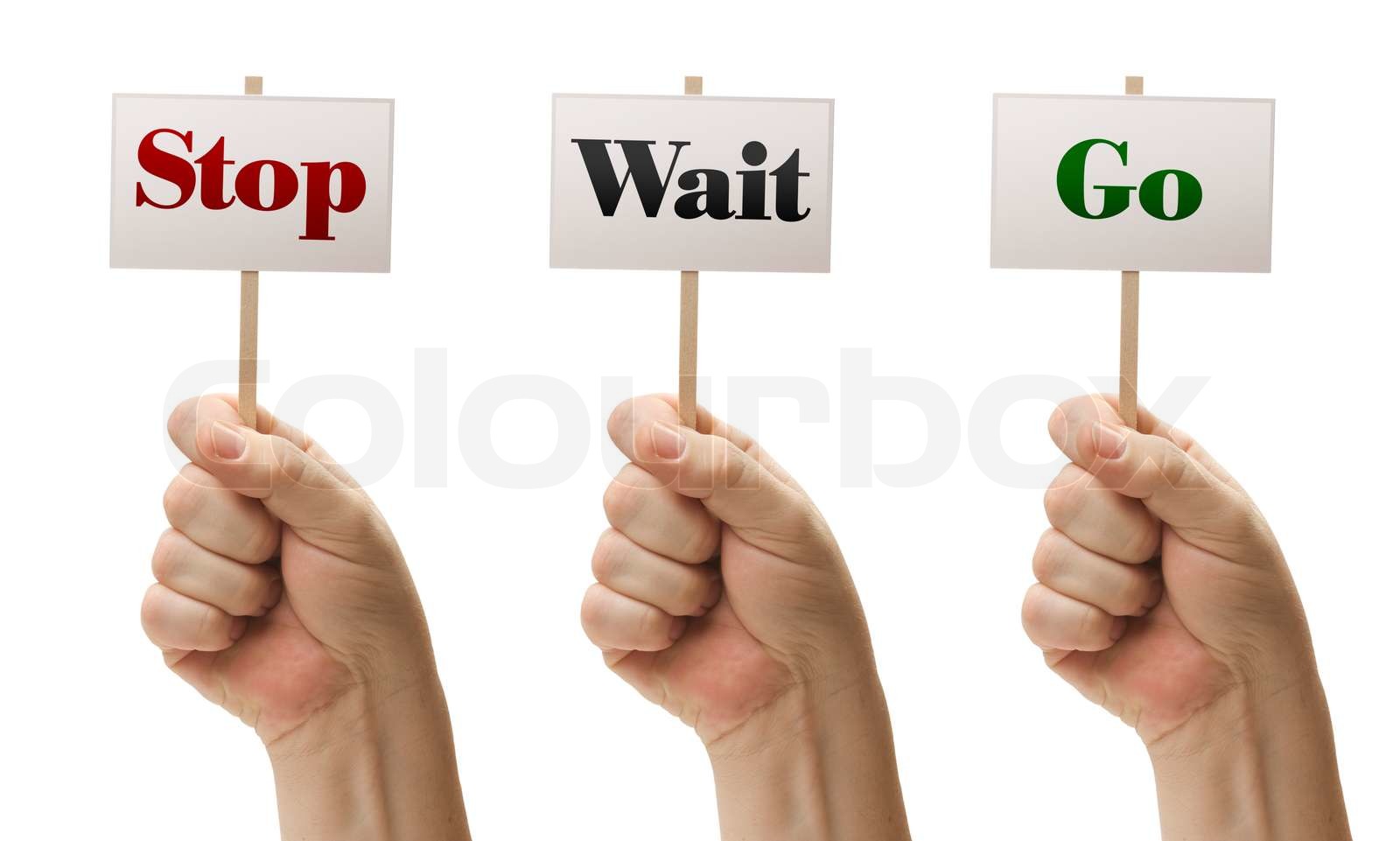 Three Signs In Fists Saying Stop, Wait and Go | Stock image | Colourbox