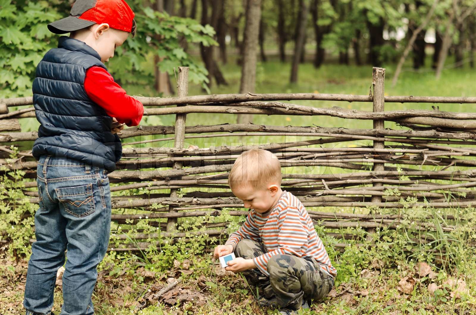 Two young boys playing with matches | Stock image | Colourbox